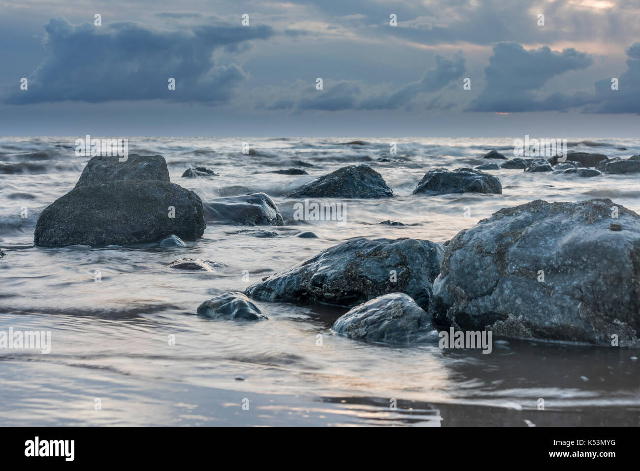 Moody grey seascape background, rock in the Irish Sea at Seascale beach ...