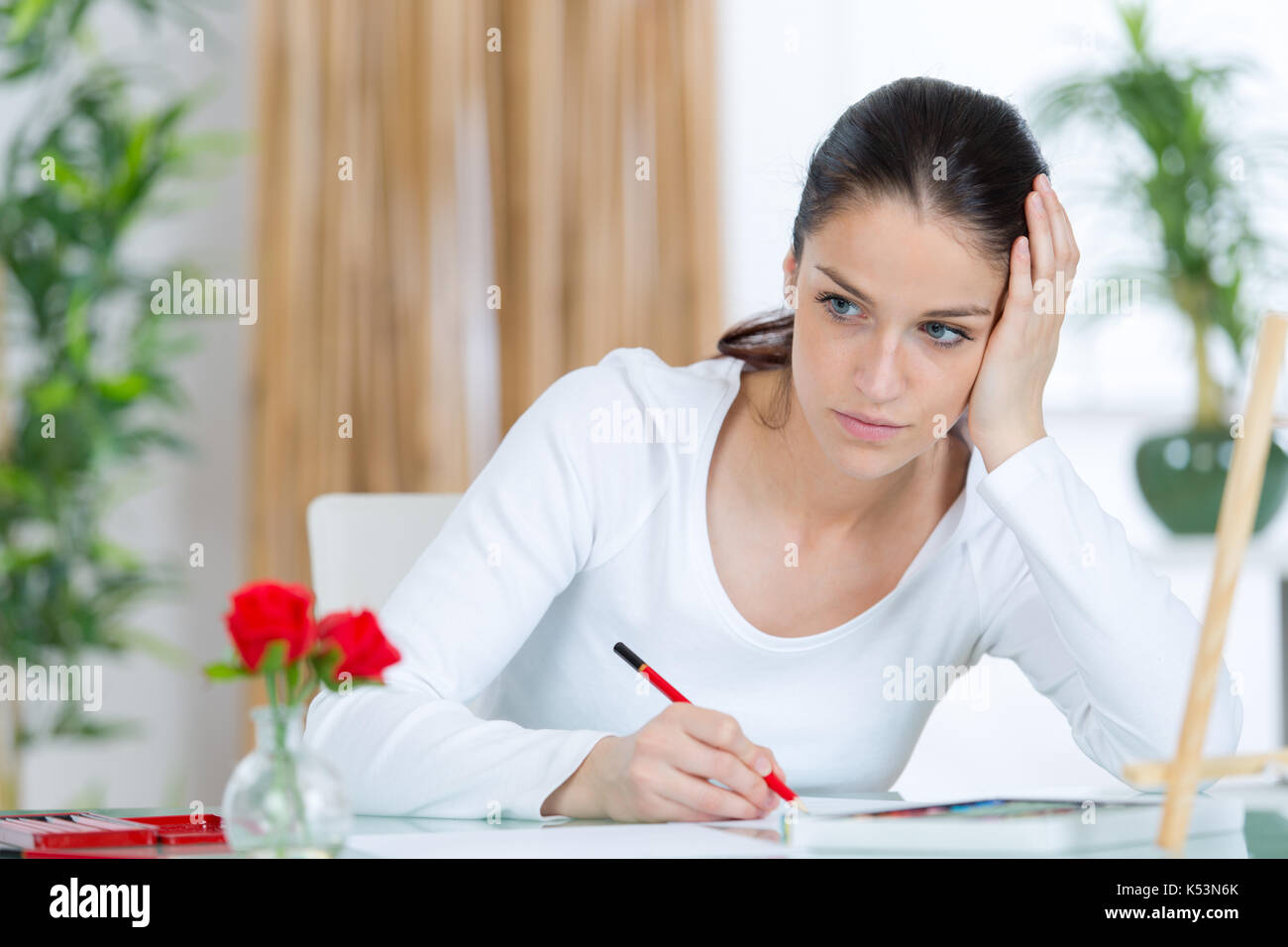 thoughtful woman while drawing Stock Photo - Alamy