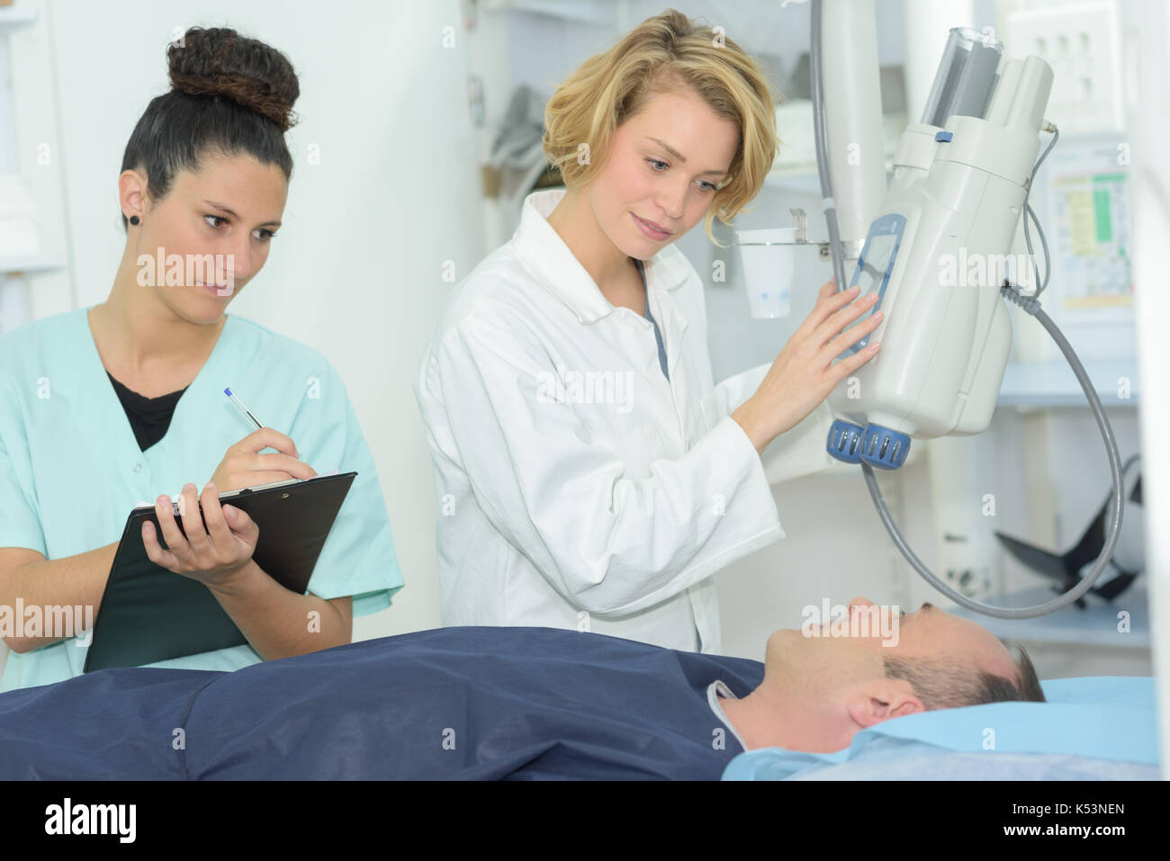 radiologic technician with doctor during magnetic resonance exam ...