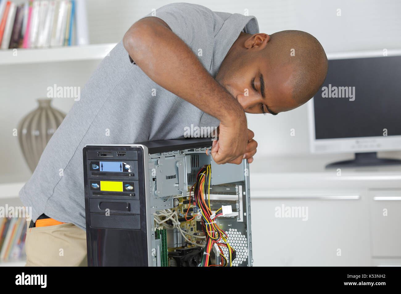 man repairing computer while sitting at his working place Stock Photo ...
