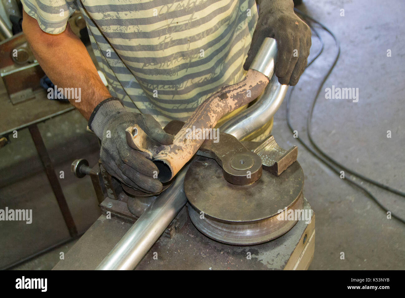 Making a car exhaust. The craftsman make exhaust pipe Stock Photo - Alamy