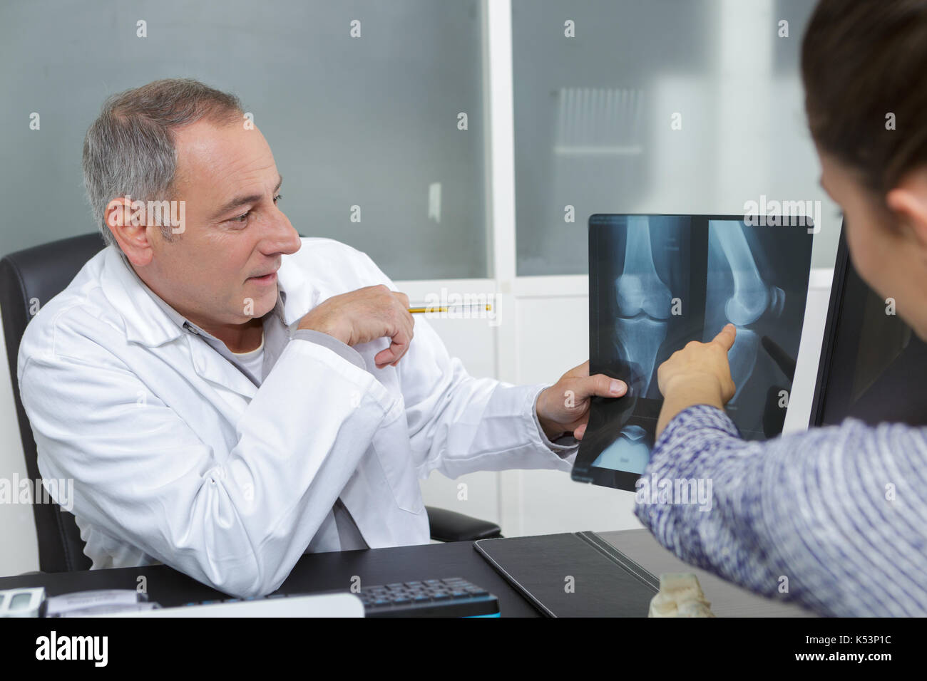 doctor with patient looking at x-ray Stock Photo - Alamy