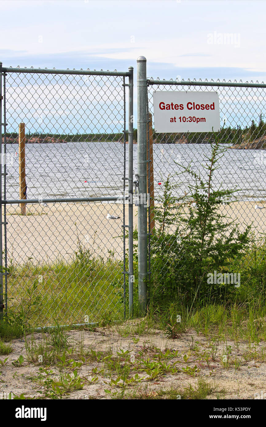 Gate closes at 10:30 pm sign at a beach Stock Photo - Alamy