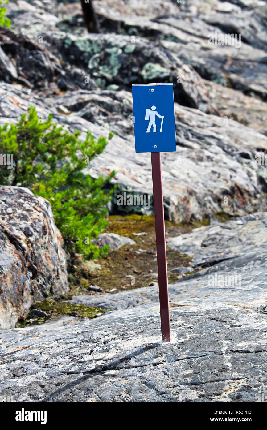 A blue hiking trail sign over rough rocks Stock Photo - Alamy