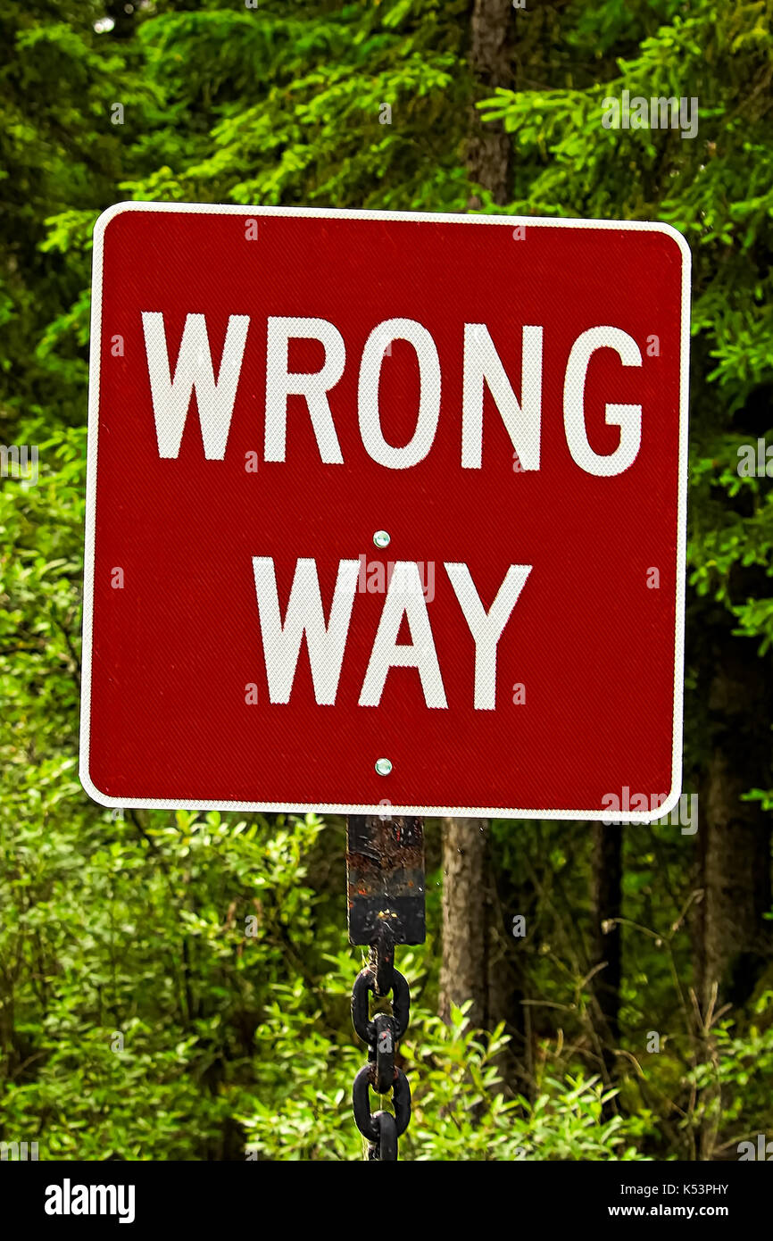 A red wrong way sign against trees Stock Photo - Alamy