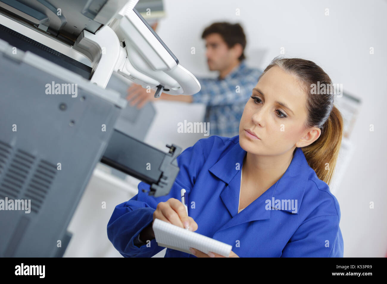 young woman checking printer malfunctions Stock Photo - Alamy