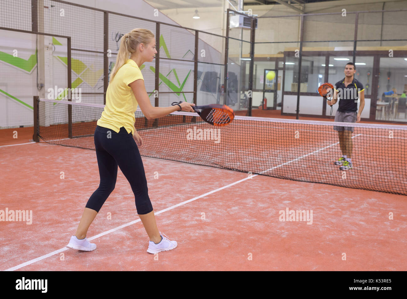 two happy indoor tennis players Stock Photo - Alamy