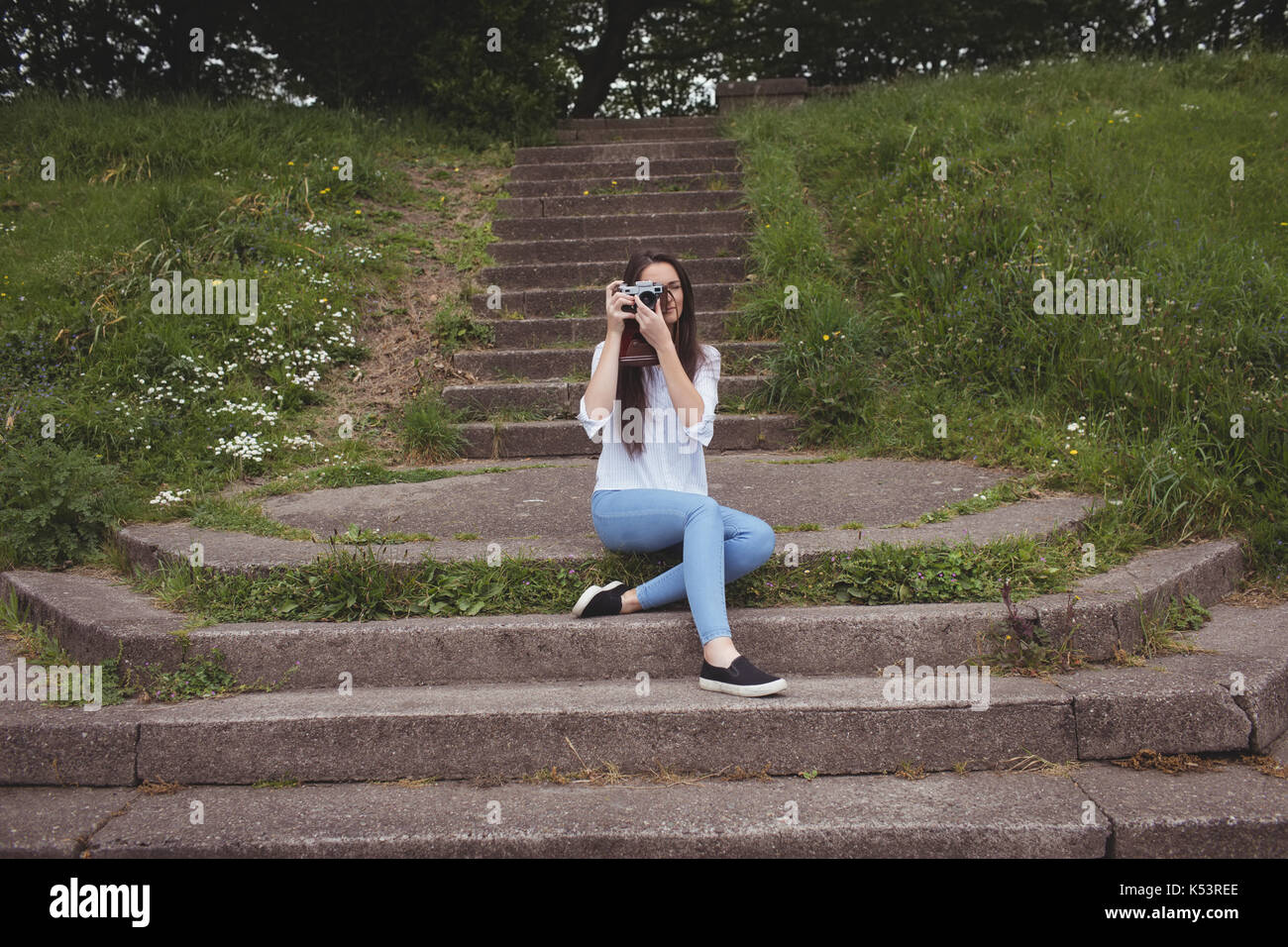 Woman clicking photos of nature in forest Stock Photo - Alamy