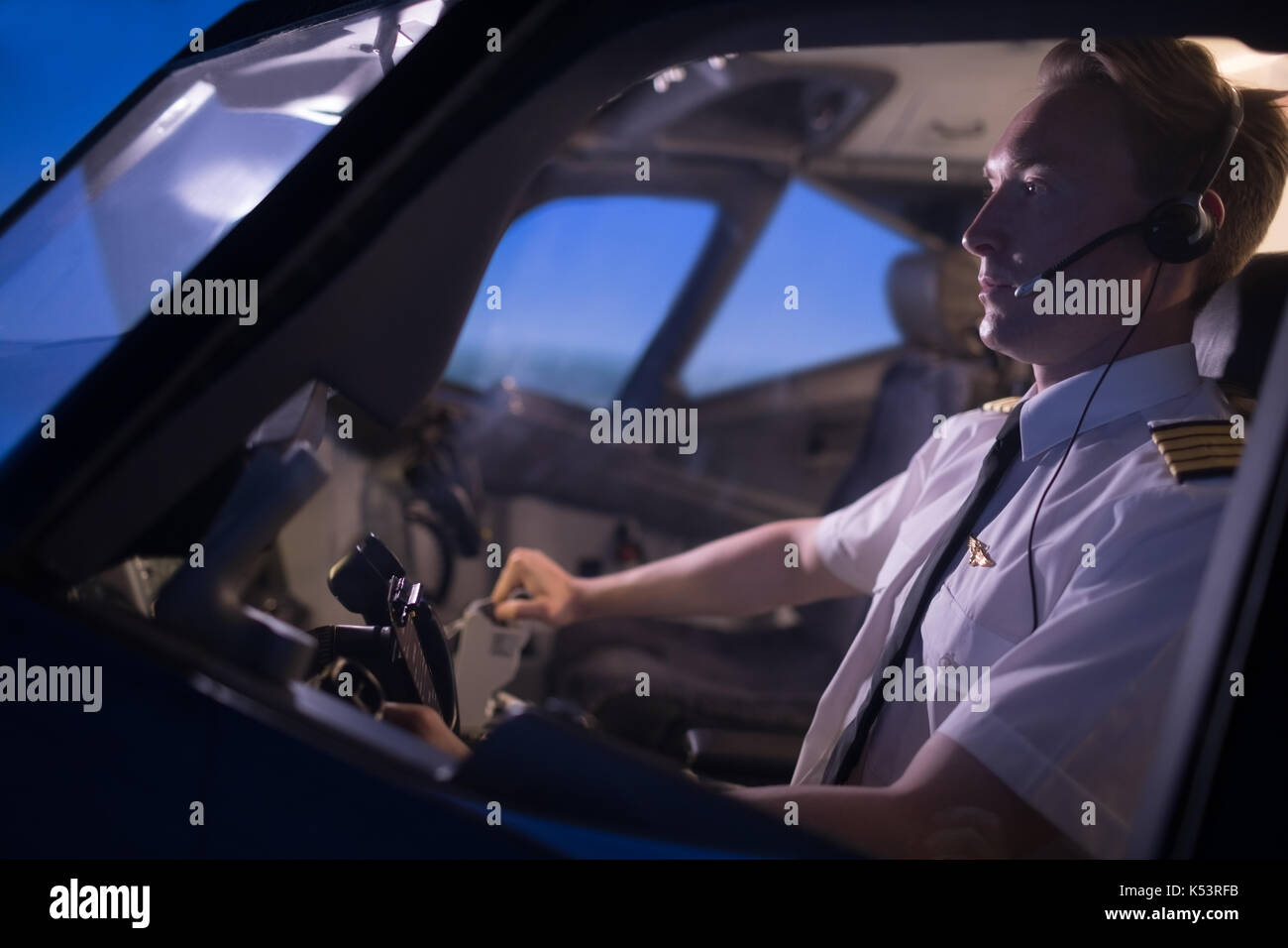 Handsome young male pilot flying airplane seen from window Stock Photo ...