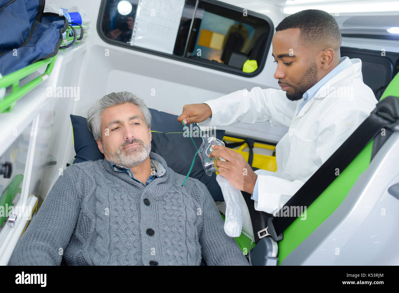 paramedics putting patient man oxygen mask in ambulance car Stock Photo ...
