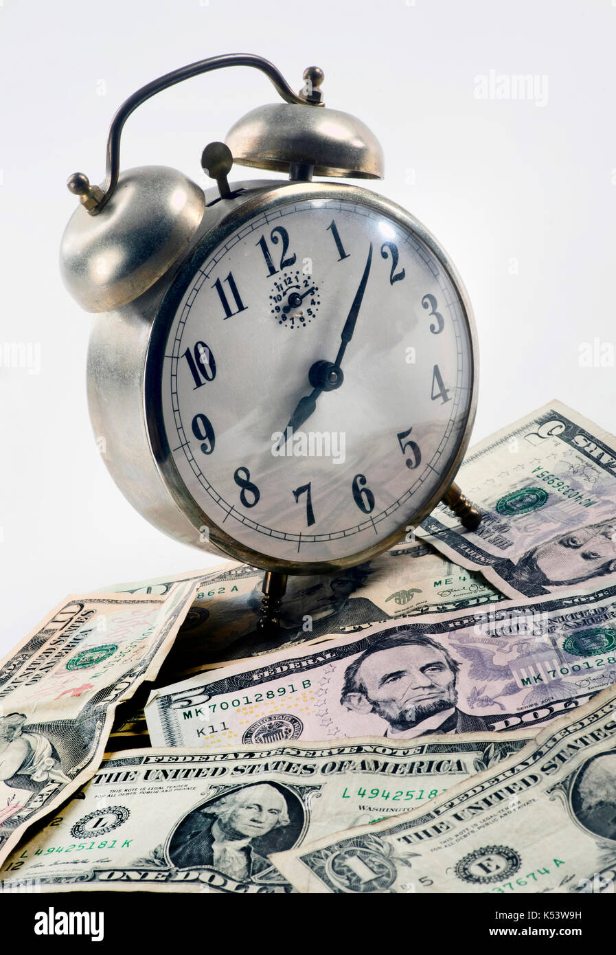 Alarm clock and cash for motivation to go to work Stock Photo - Alamy