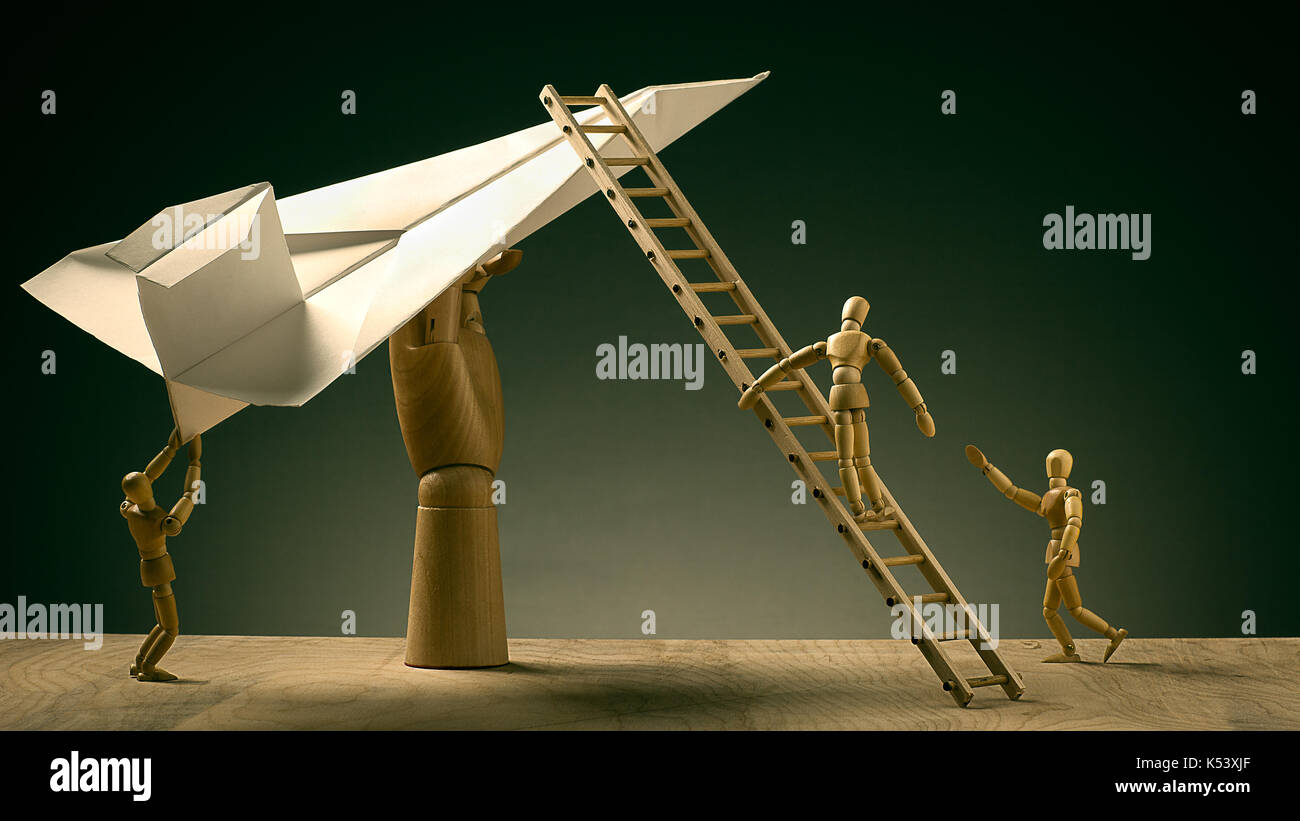 Men prepare a paper airplane for take off. Ground crew getting ready ...