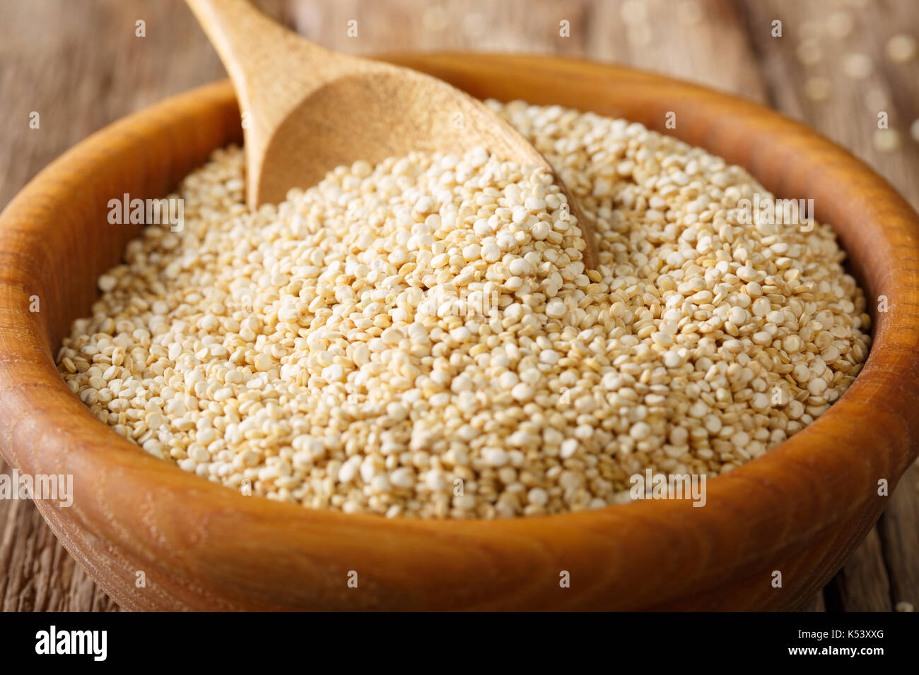 Traditional raw quinoa close up in a wooden bowl on the table ...