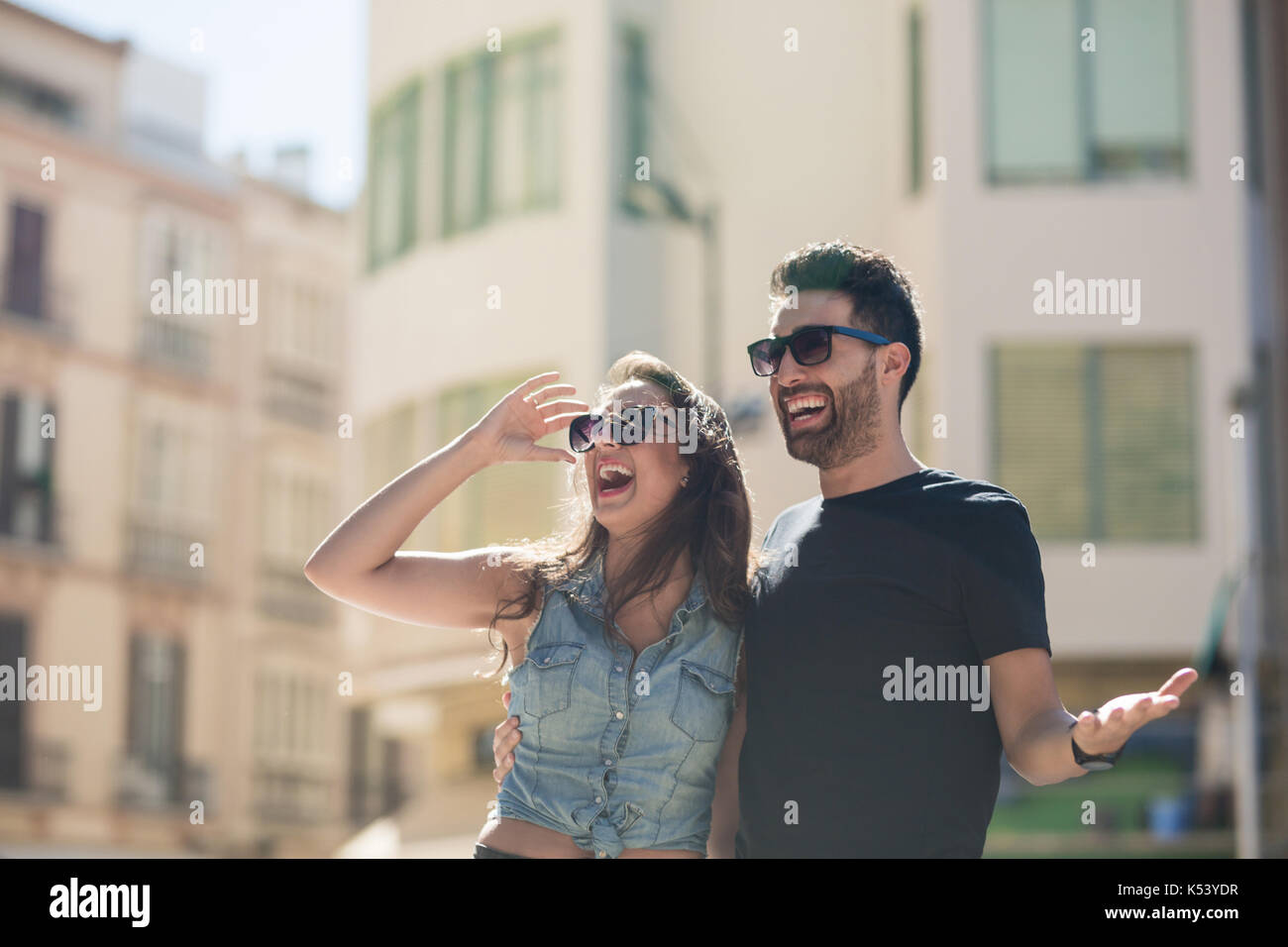 Portrait of young happy couple embracing each other splitting their ...