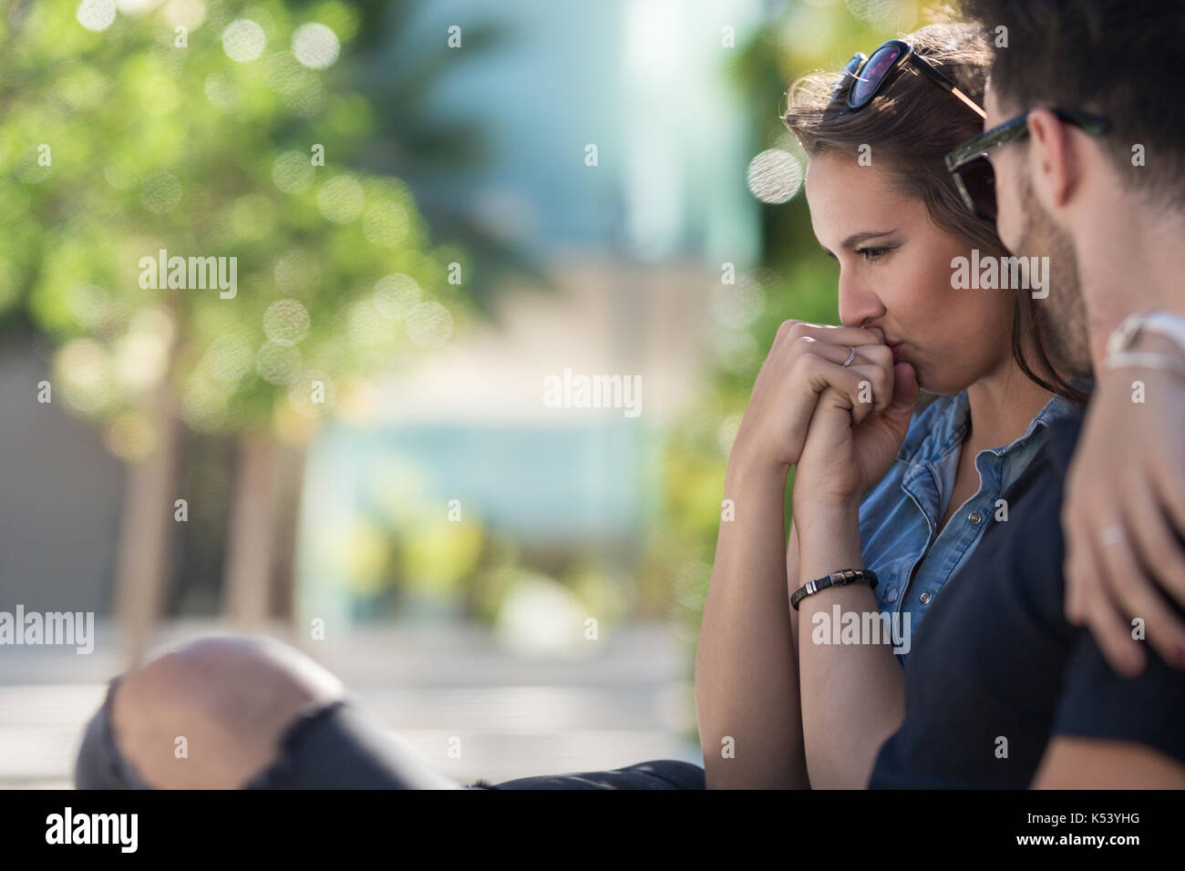 Profile portrait of young woman cuddling with boyfriend kissing his ...