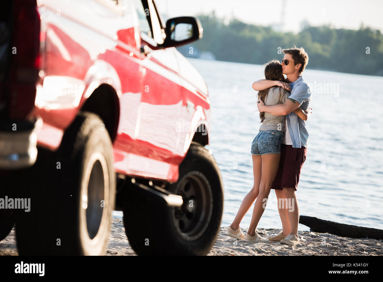 couple hugging near car Stock Photo - Alamy