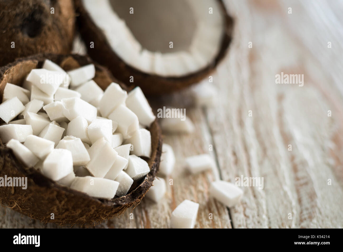 Coconut pieces in shell with coconut on background Stock Photo - Alamy