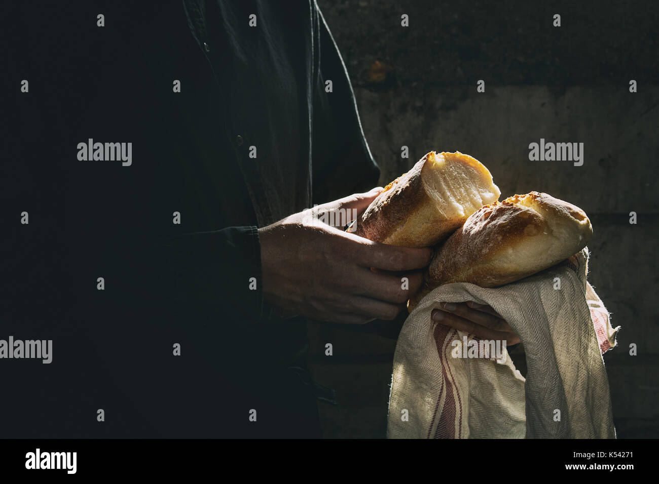 Fresh baked bread in hands Stock Photo - Alamy
