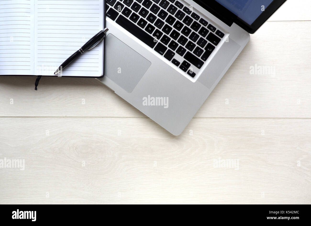 Notepad and laptop computer overhead Stock Photo - Alamy