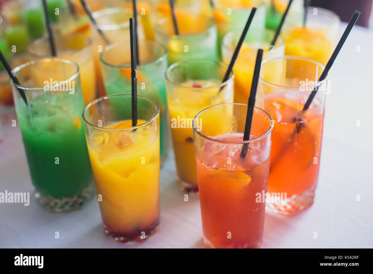 Beautiful line of different coloured alcohol cocktails on a open air ...