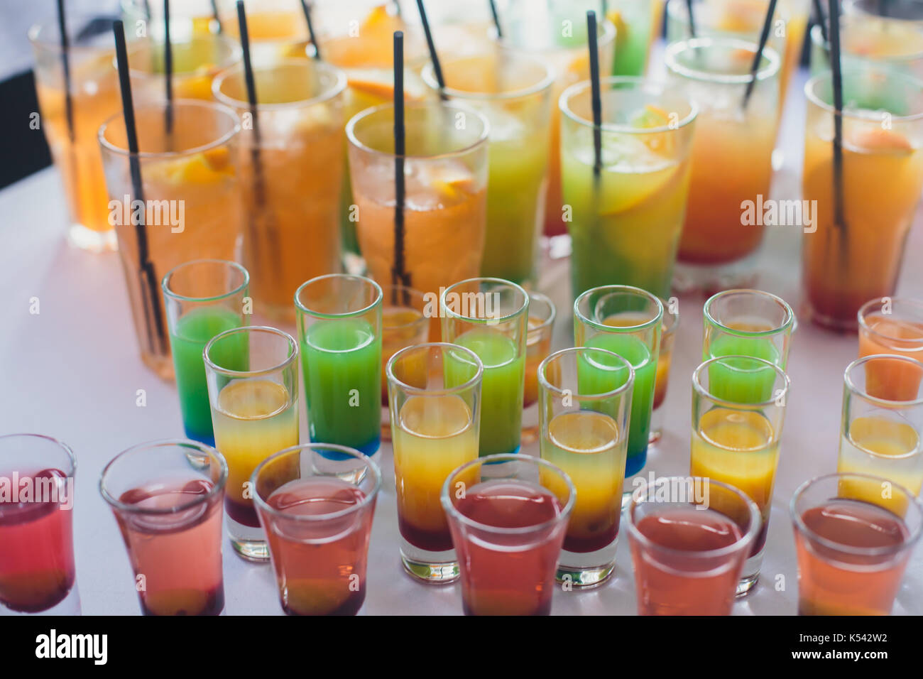 Beautiful line of different coloured alcohol cocktails on a open air ...