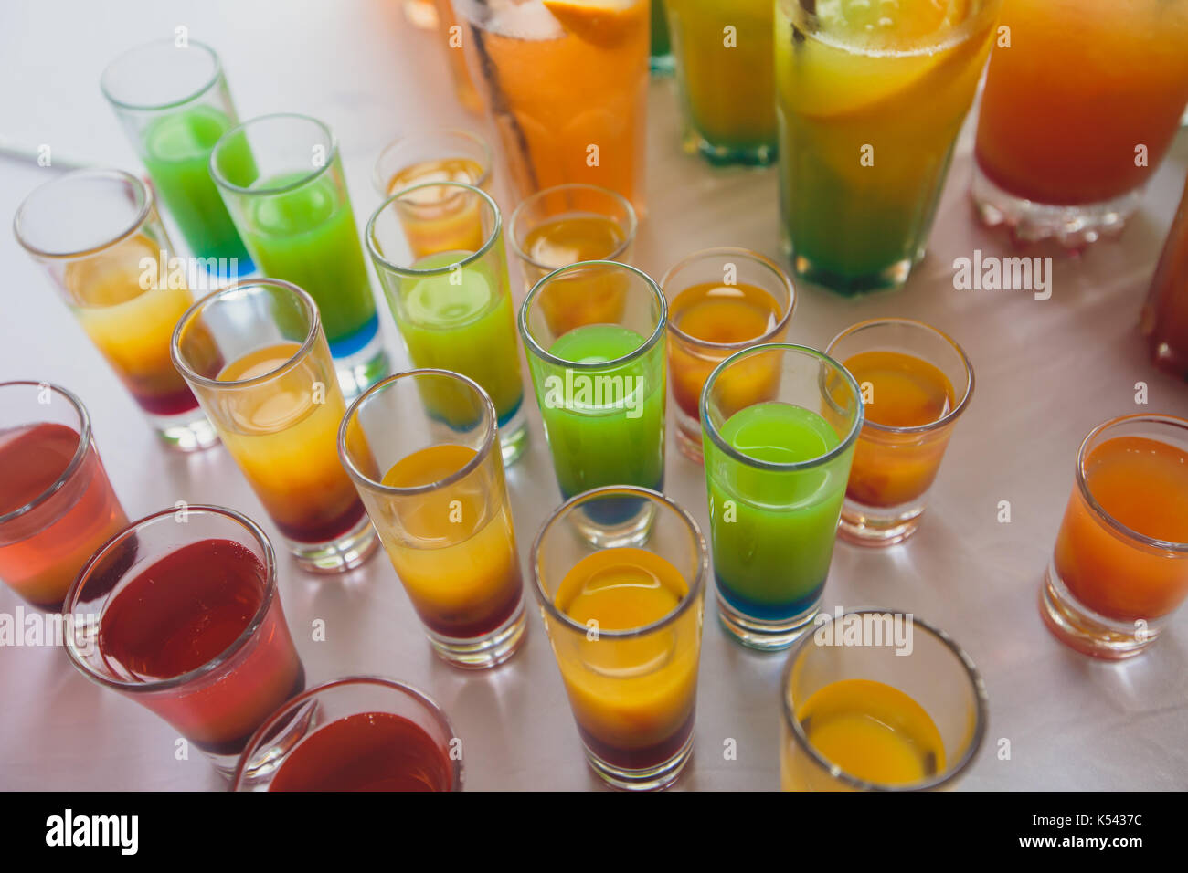 Beautiful line of different coloured alcohol cocktails on a open air ...
