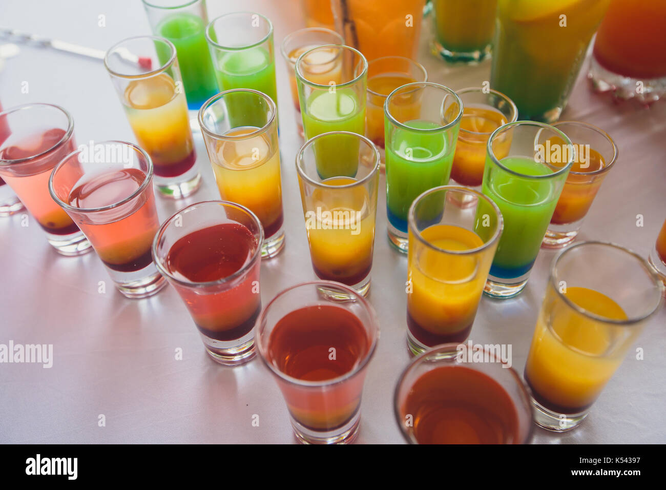 Beautiful line of different coloured alcohol cocktails on a open air ...