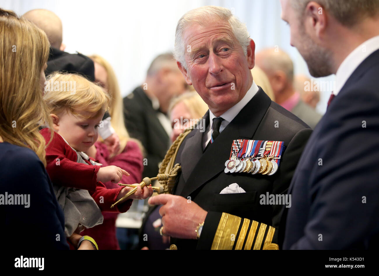18 month old Imogen Holm pulls the braid on the uniform of the Prince ...