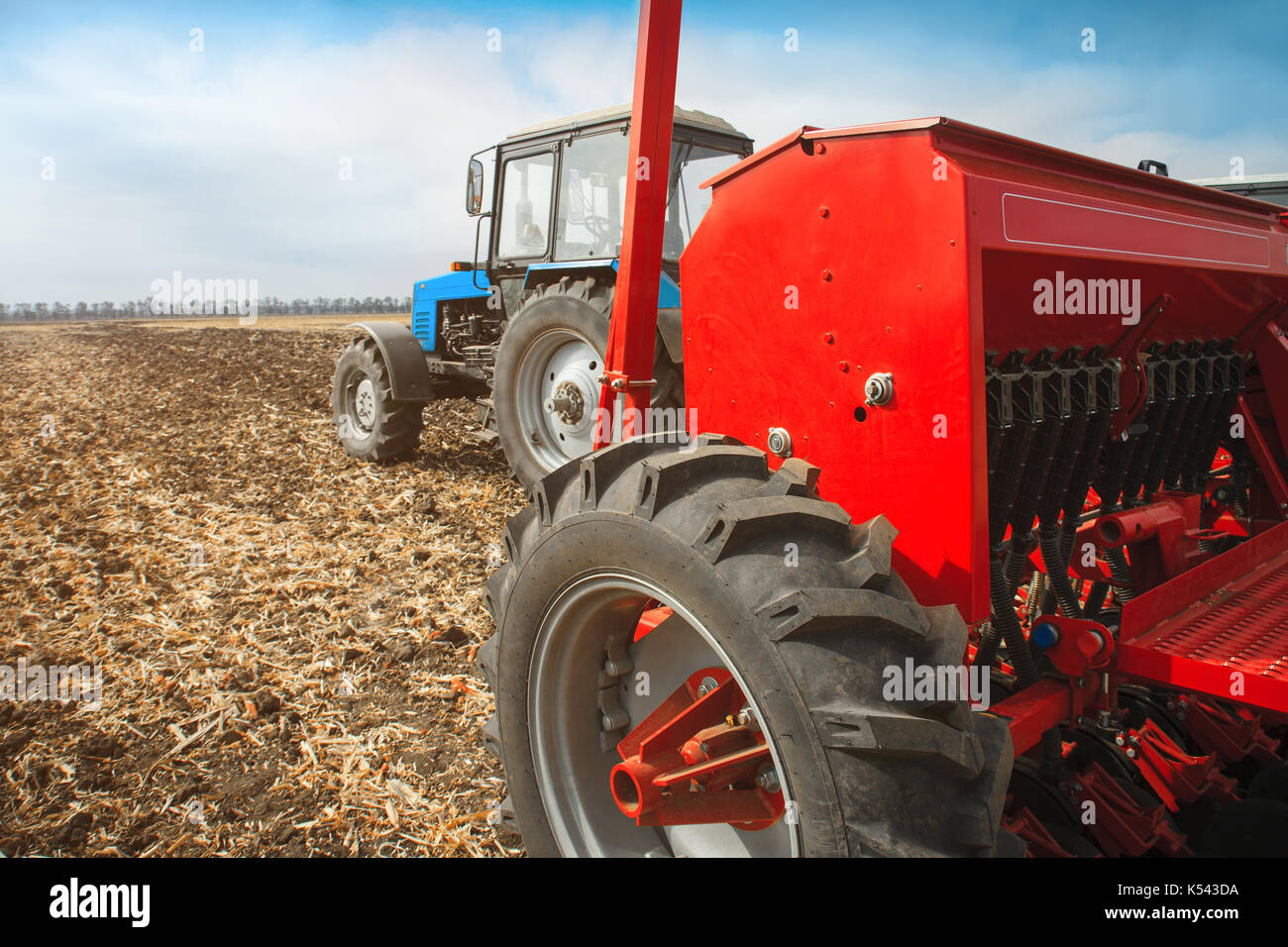 Modern tractor with sowing complex on the field. The concept of work in ...