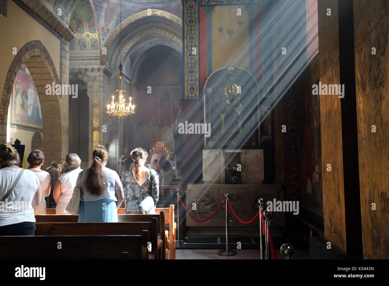 Light streams through the window onto worshippers during a service at ...