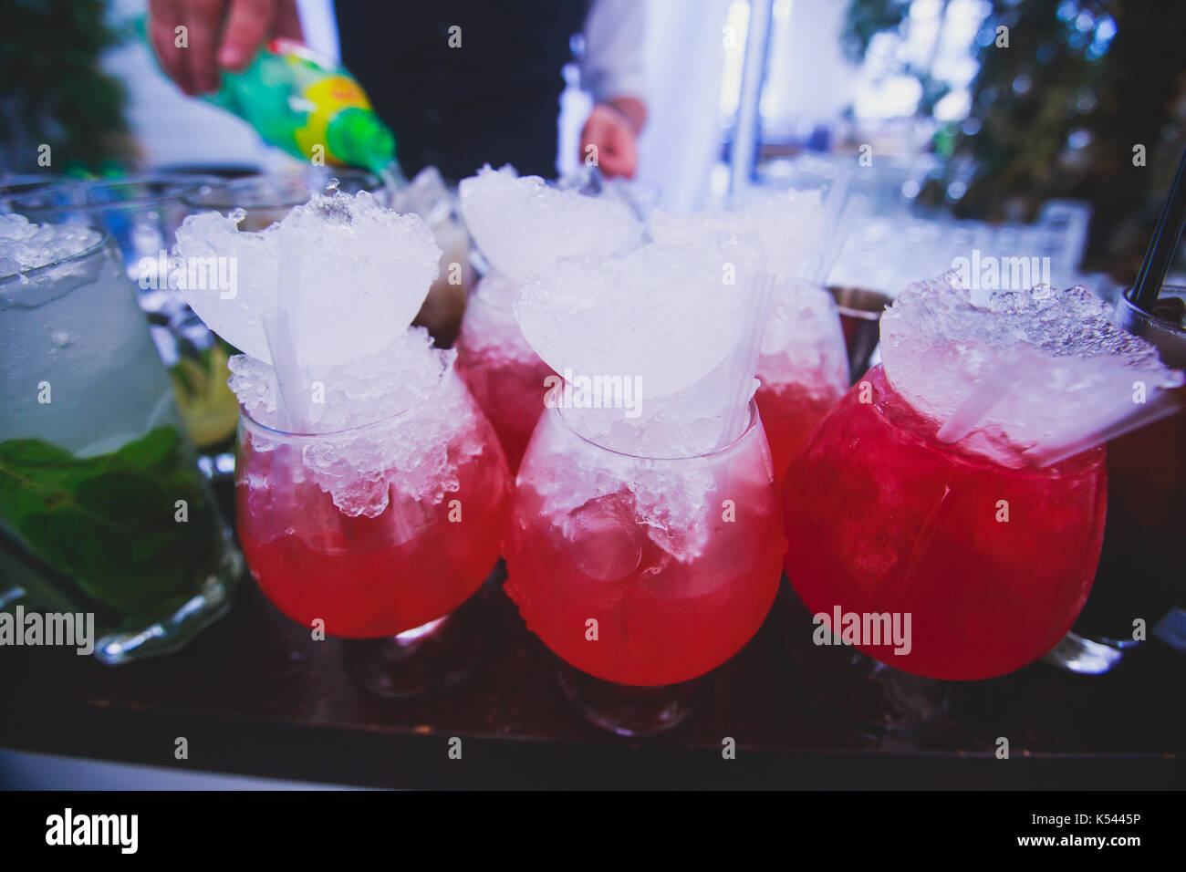 Beautiful line of different coloured alcohol cocktails on a open air ...