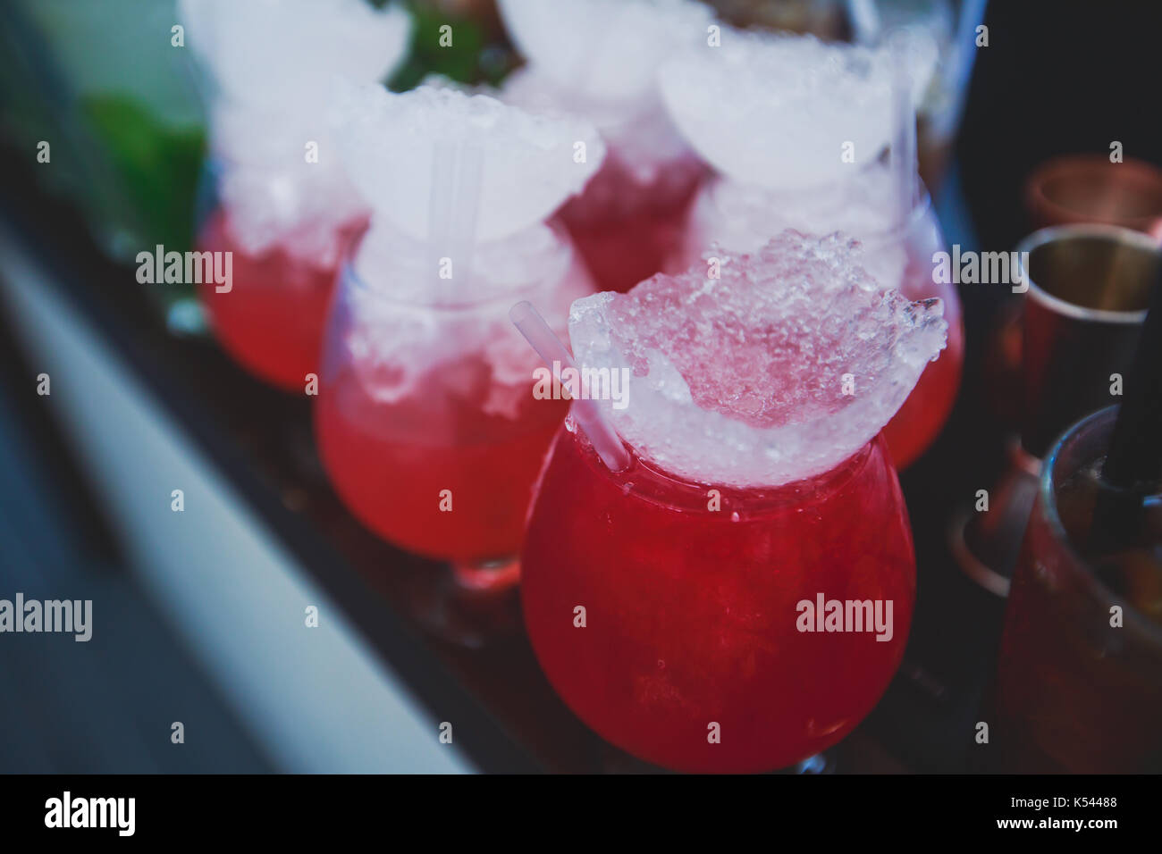 Beautiful line of different coloured alcohol cocktails on a open air ...