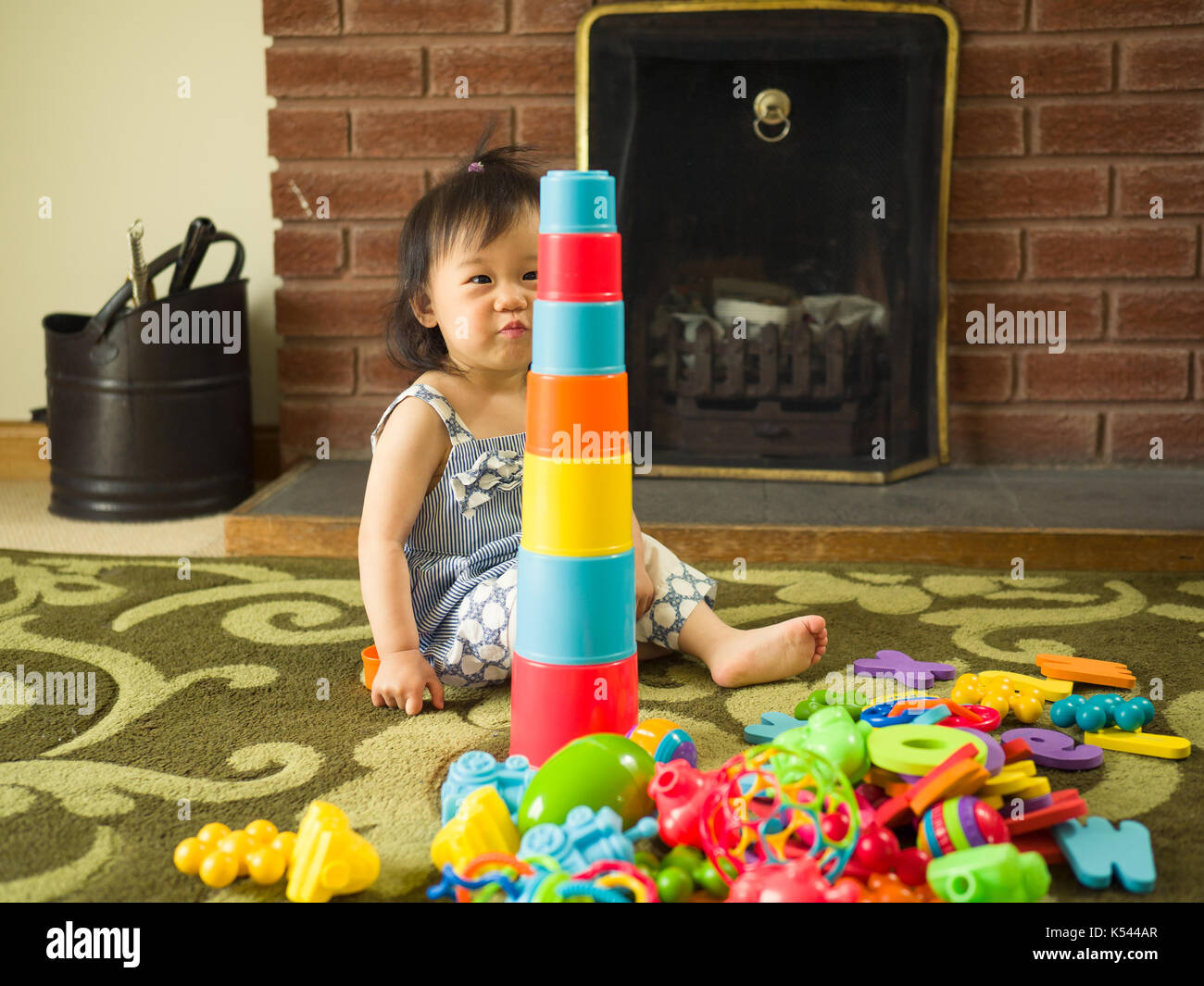 baby girl playing stacking cups at home Stock Photo - Alamy
