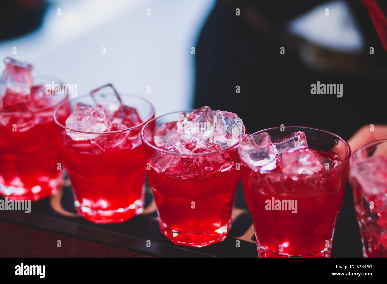 Beautiful line of different coloured alcohol cocktails on a open air ...