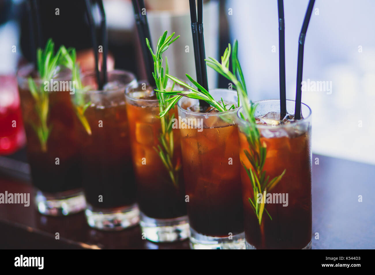 Beautiful line of different coloured alcohol cocktails on a open air ...