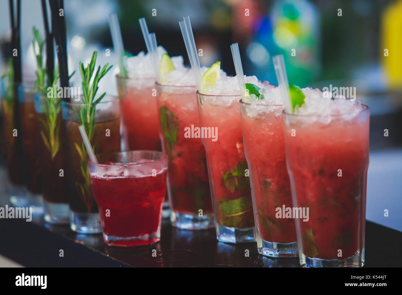 Beautiful line of different coloured alcohol cocktails on a open air ...