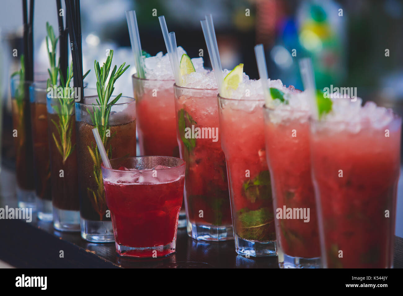 Beautiful line of different coloured alcohol cocktails on a open air ...