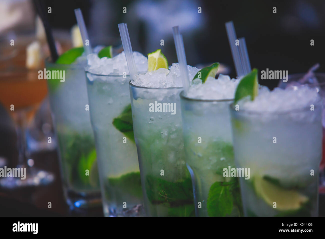Beautiful line of different coloured alcohol cocktails on a open air ...