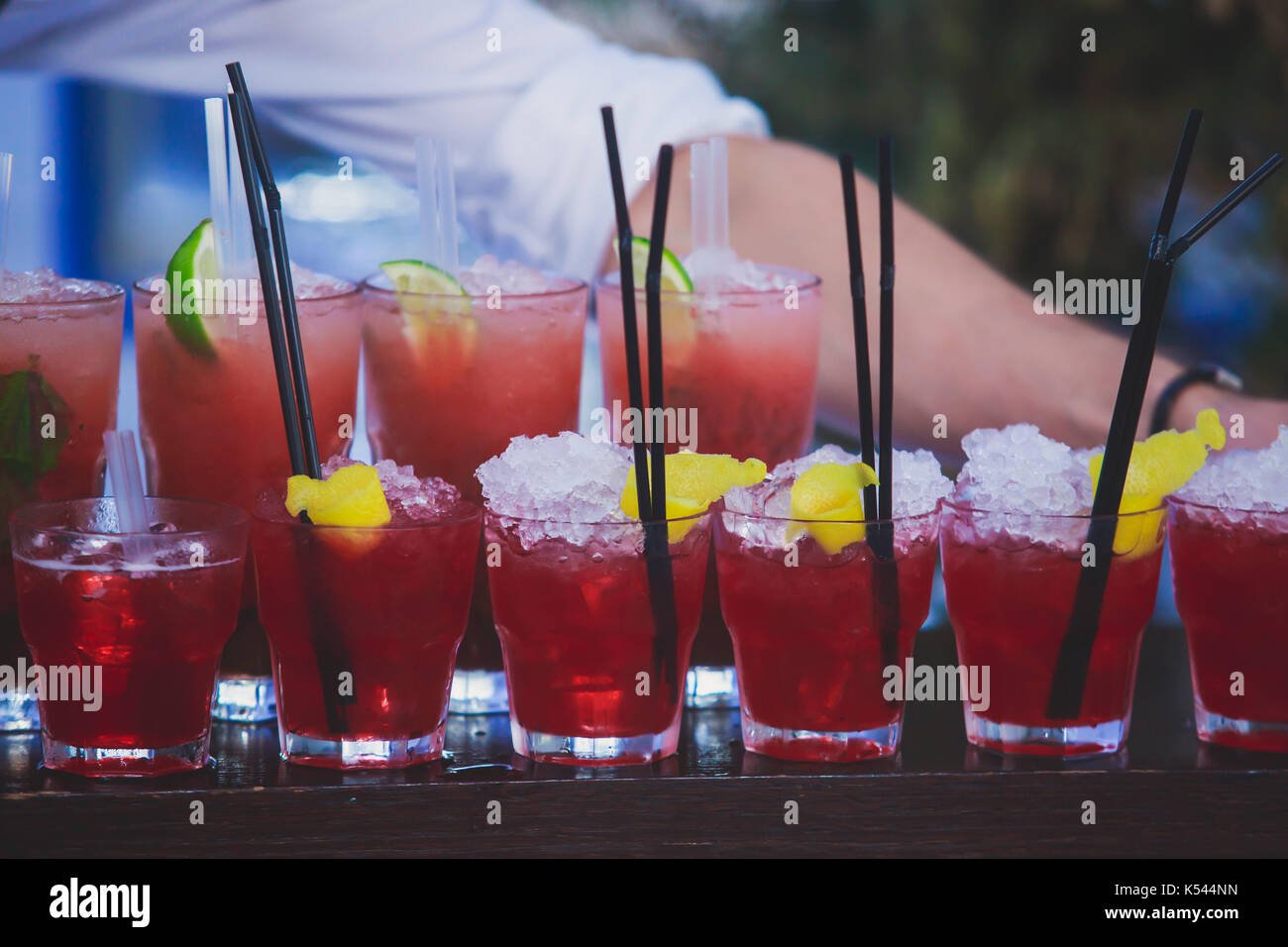 Beautiful line of different coloured alcohol cocktails on a open air ...