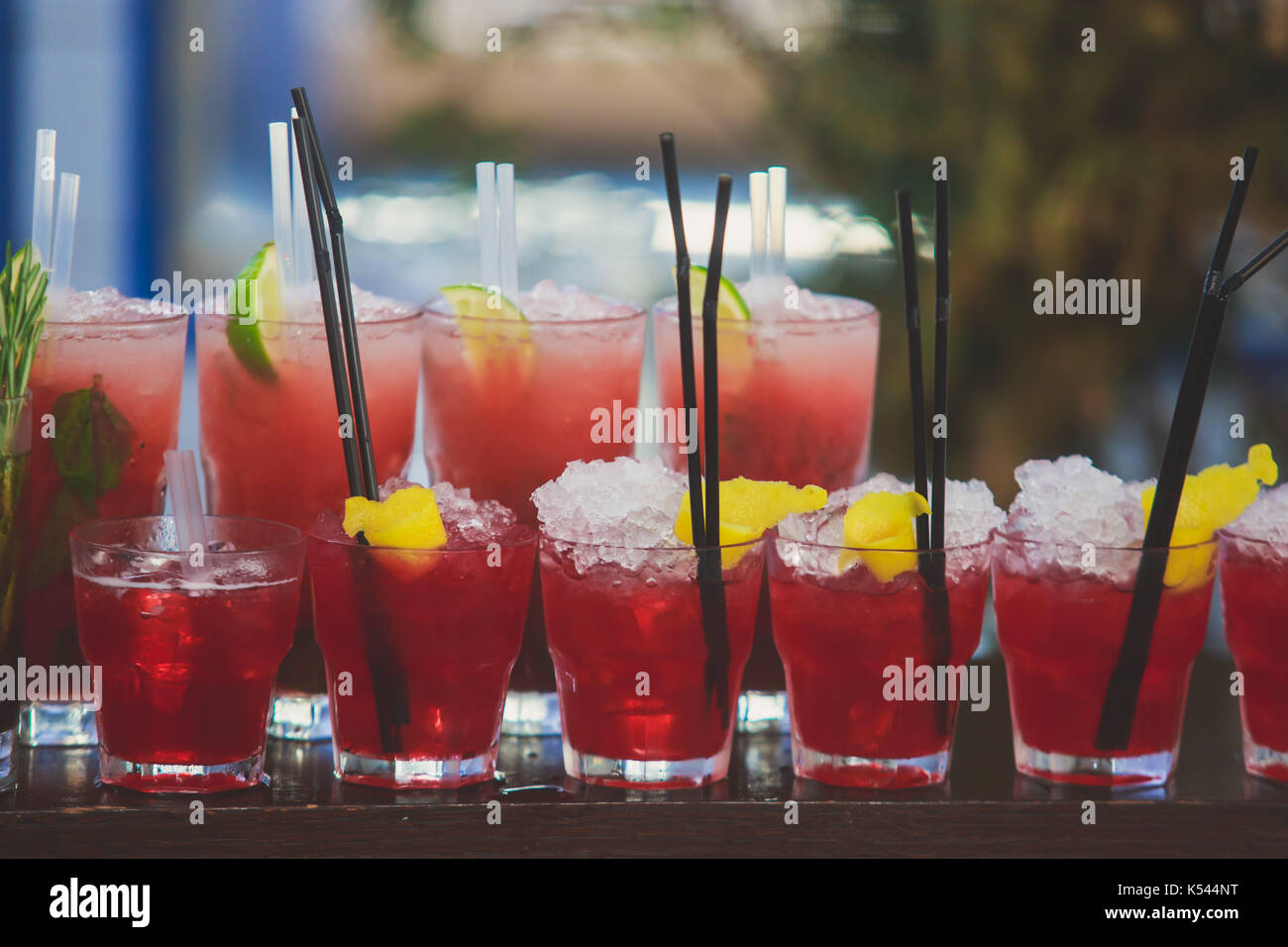 Beautiful line of different coloured alcohol cocktails on a open air ...