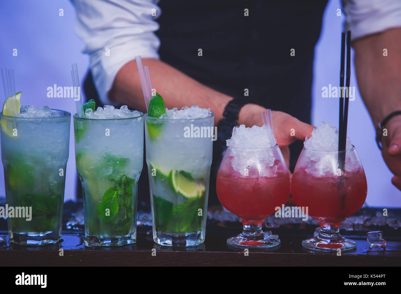 Beautiful line of different coloured alcohol cocktails on a open air ...