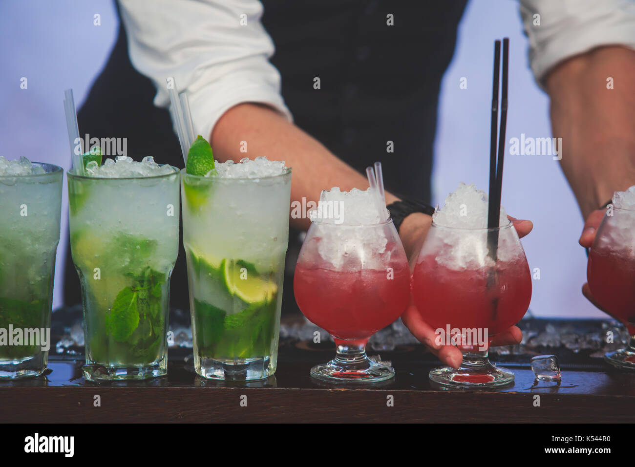 Beautiful line of different coloured alcohol cocktails on a open air ...