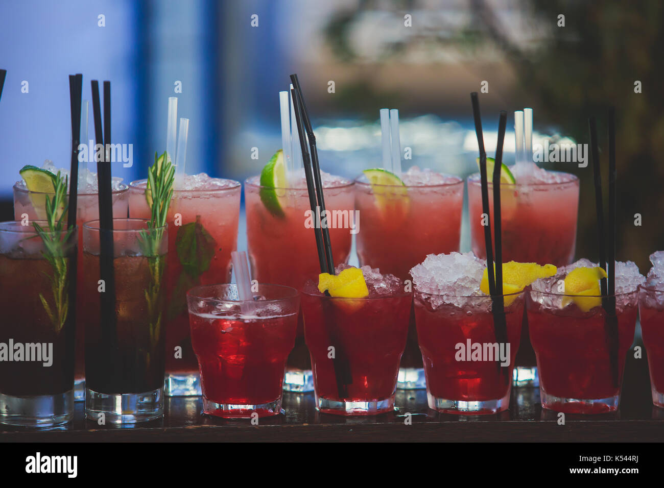 Beautiful line of different coloured alcohol cocktails on a open air ...