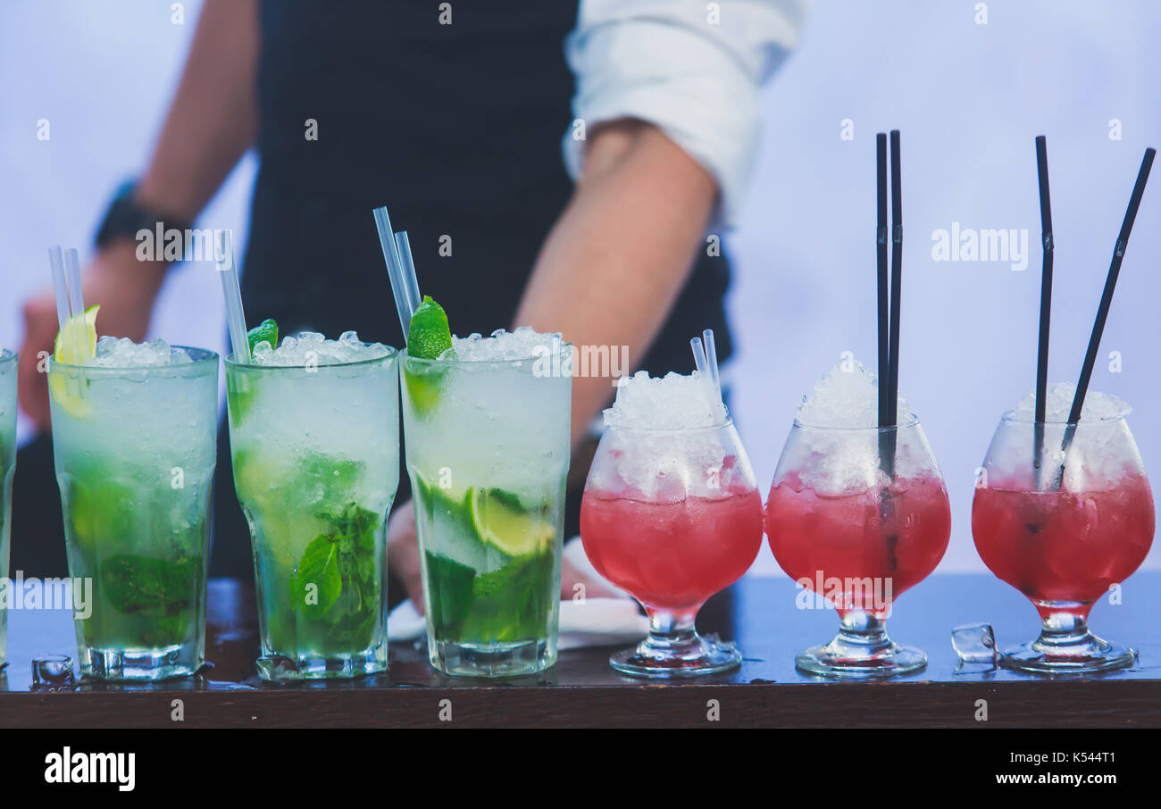 Beautiful line of different coloured alcohol cocktails on a open air ...