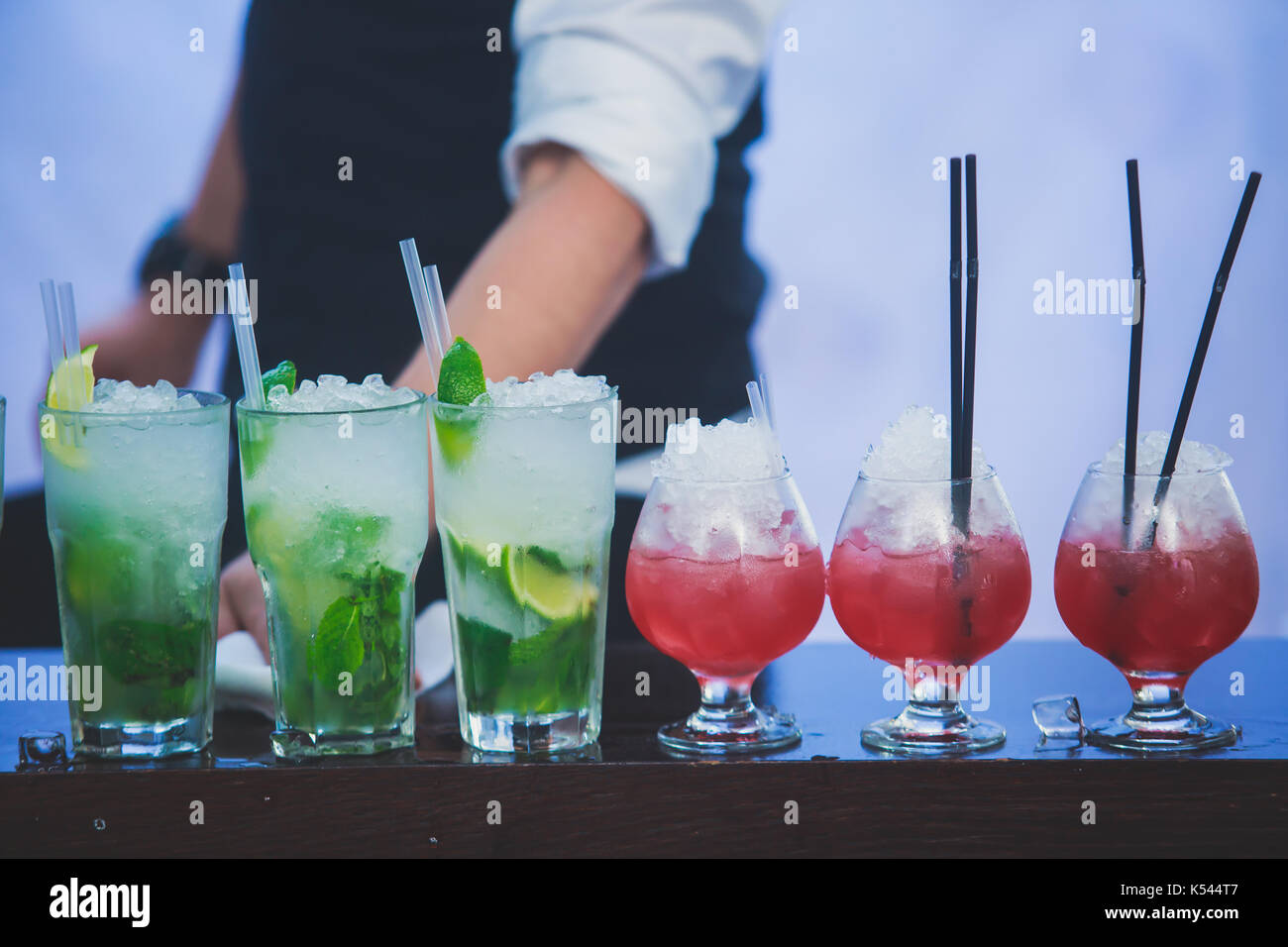 Beautiful line of different coloured alcohol cocktails on a open air ...