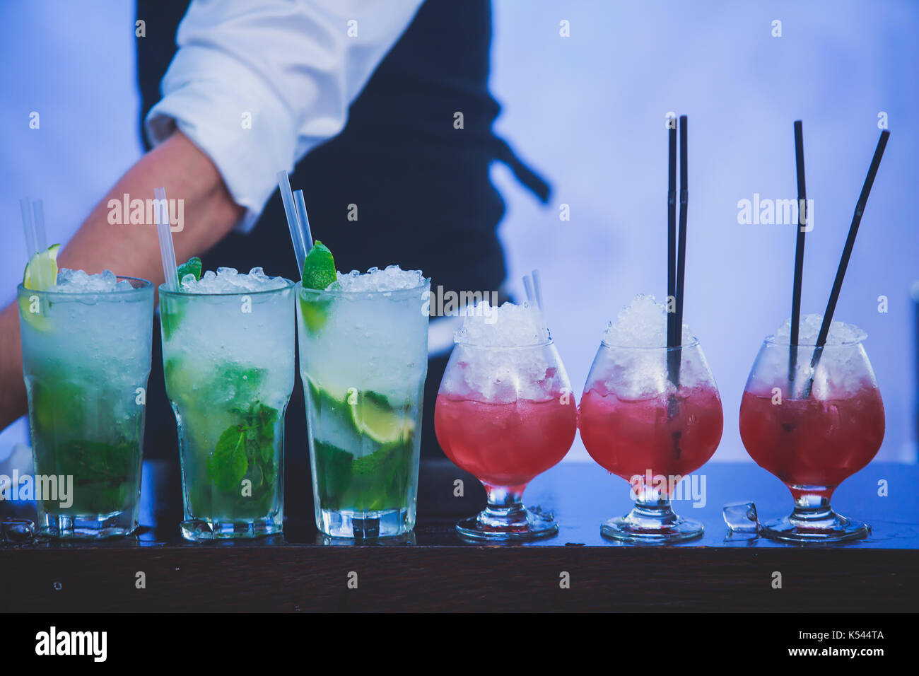 Beautiful line of different coloured alcohol cocktails on a open air ...