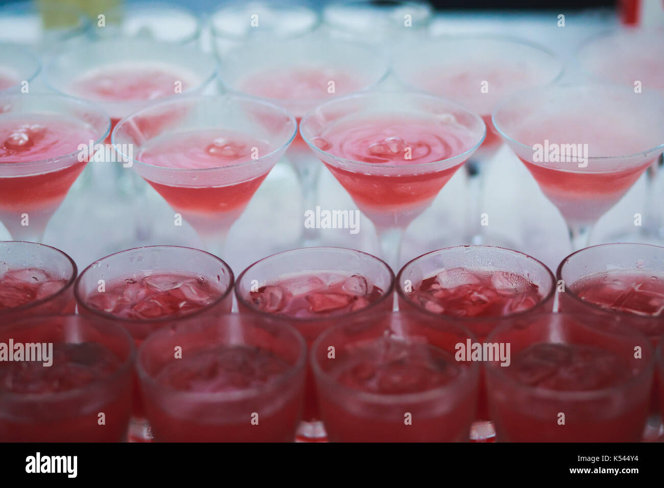 Beautiful line of different coloured alcohol cocktails on a open air ...