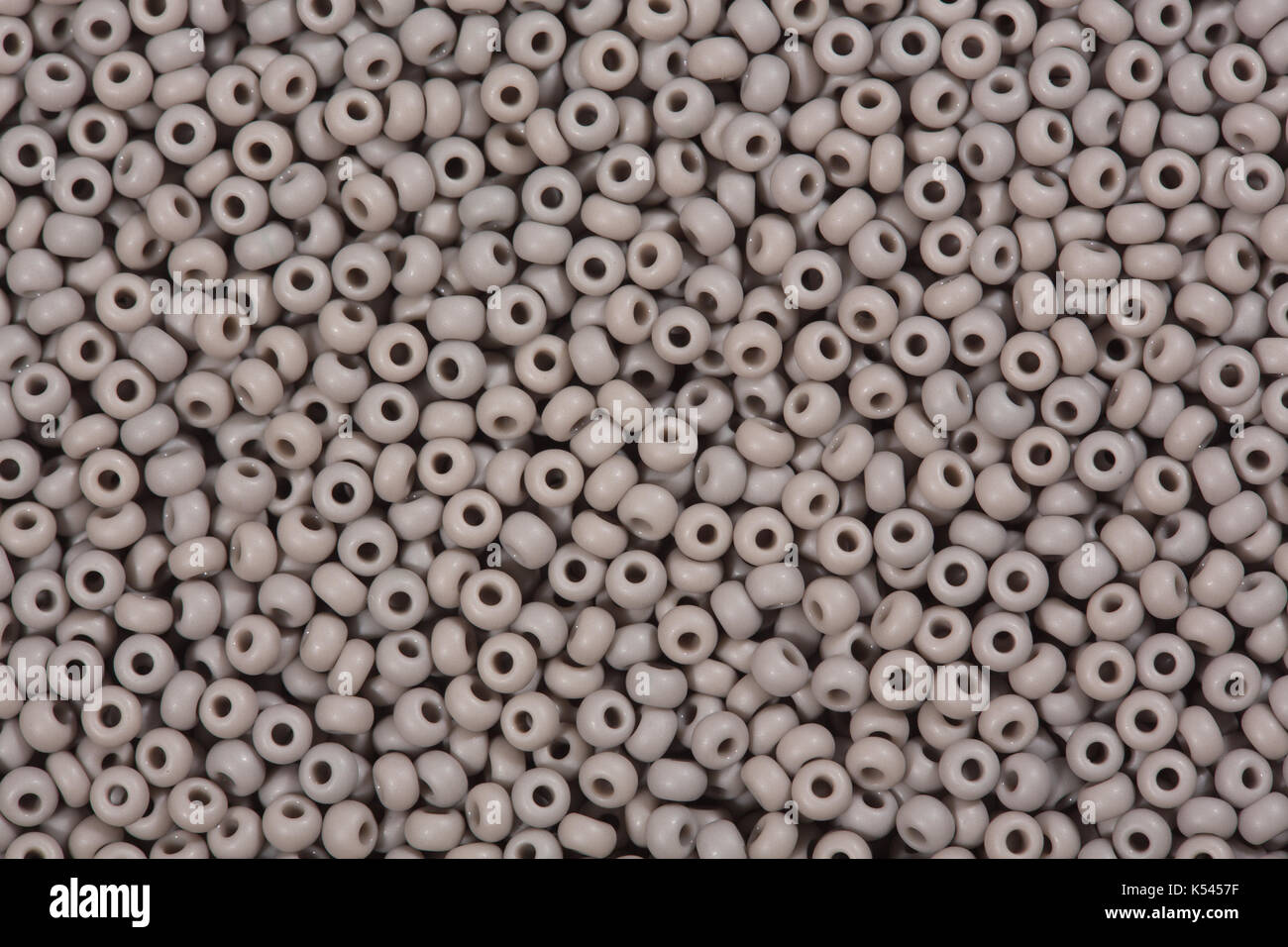 Close up of light grey seed beads background. High resolution photo ...