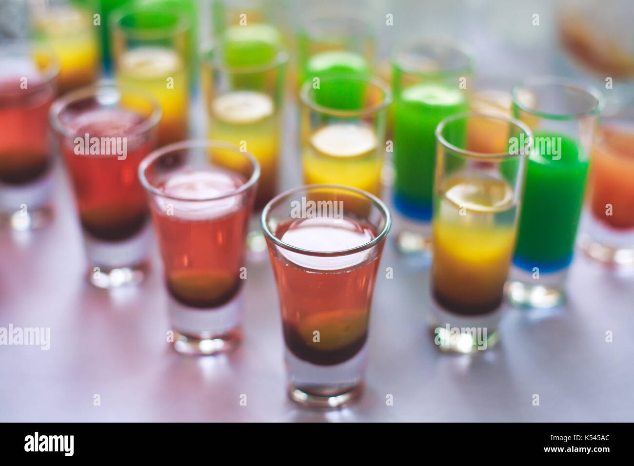 Beautiful line of different coloured alcohol cocktails on a open air ...