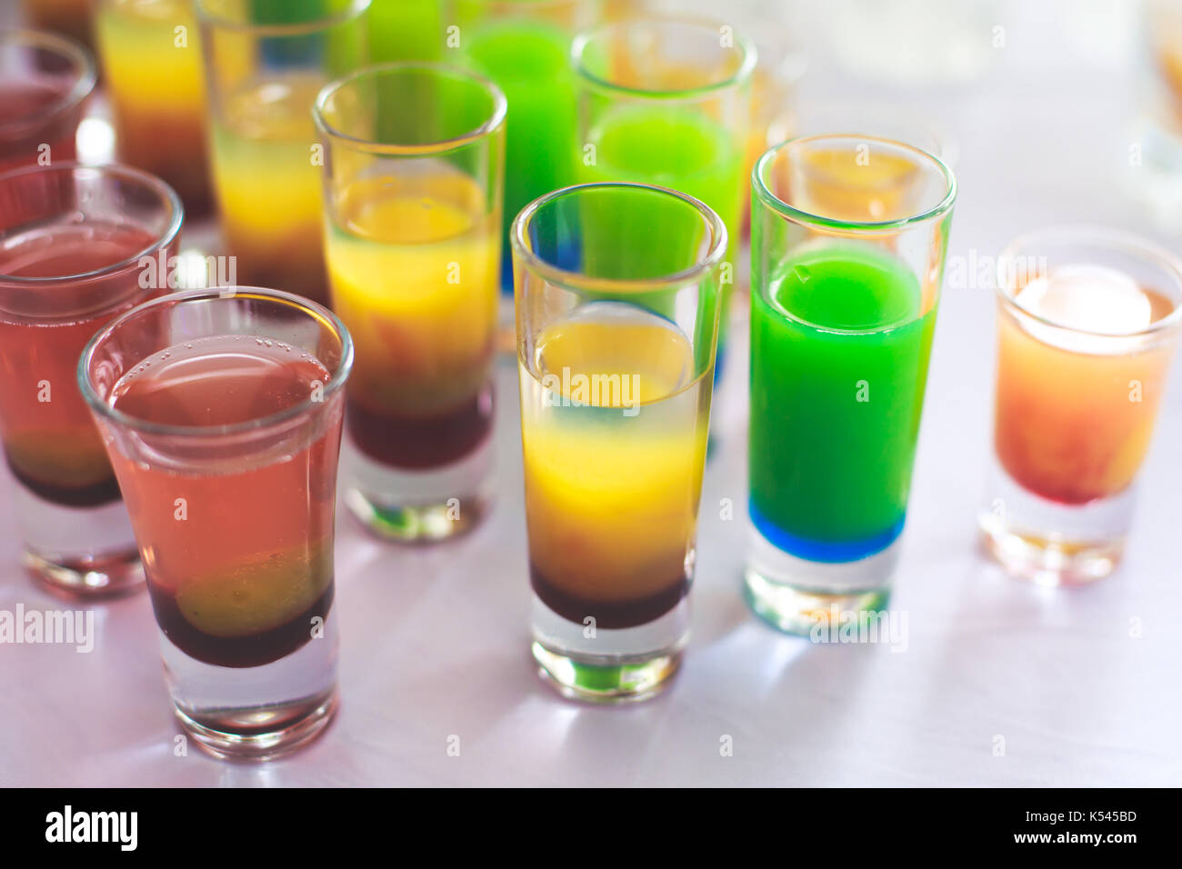 Beautiful line of different coloured alcohol cocktails on a open air ...